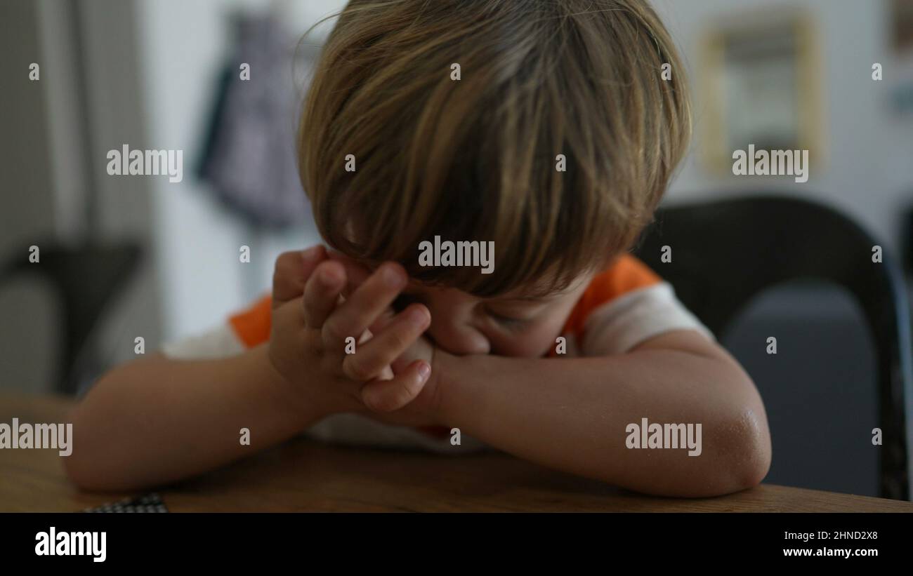 Child rubbing face and nose with hands Stock Photo - Alamy
