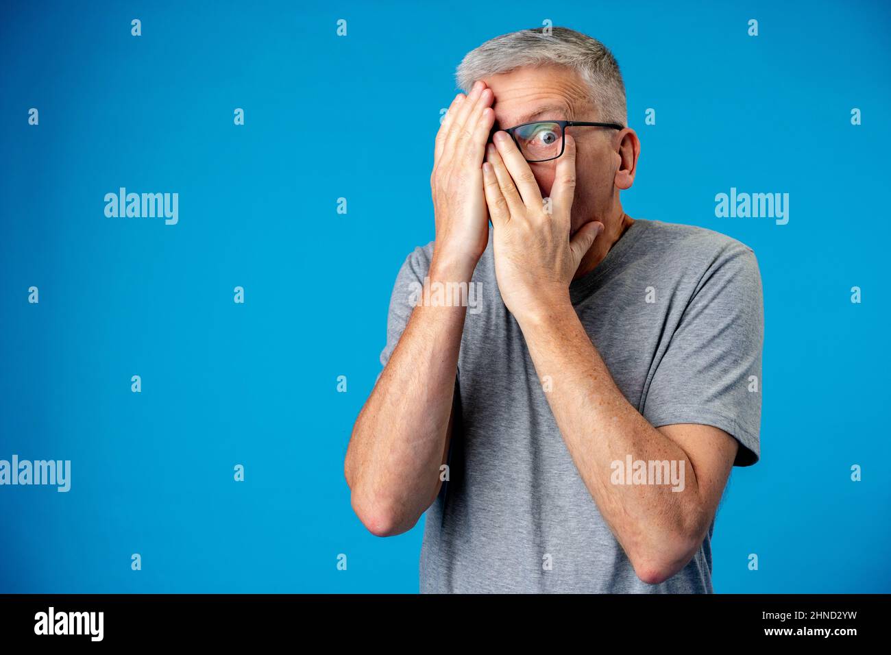 Scared middle age man nervous expressing anxiety and panic gesture ...