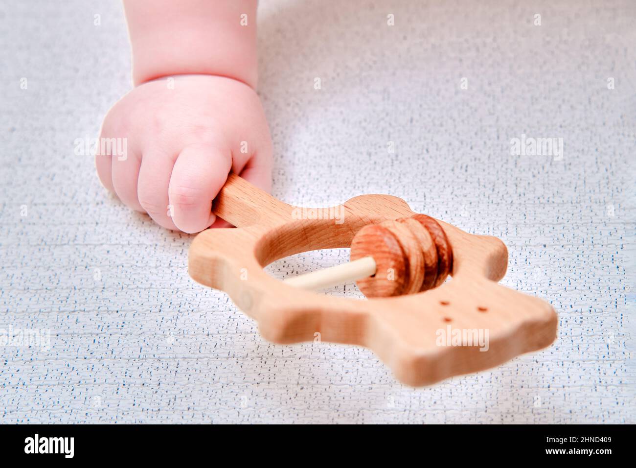 Baby hand and toy rattle abacus, close-up. Children fingers and an ...