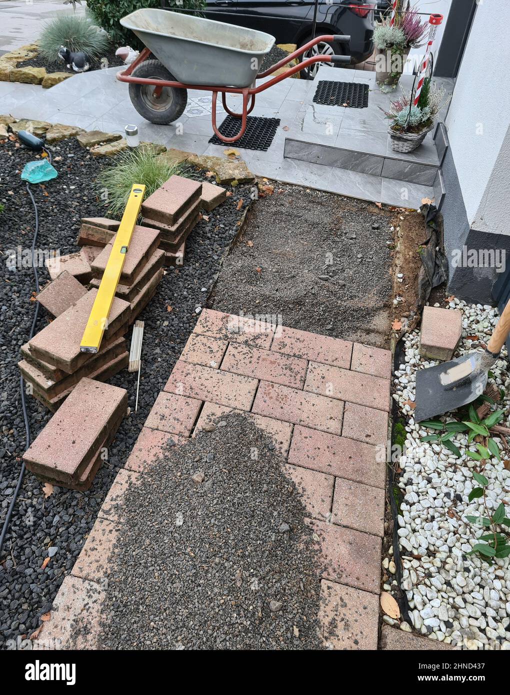 Worker laying pavement rocks Stock Photo - Alamy