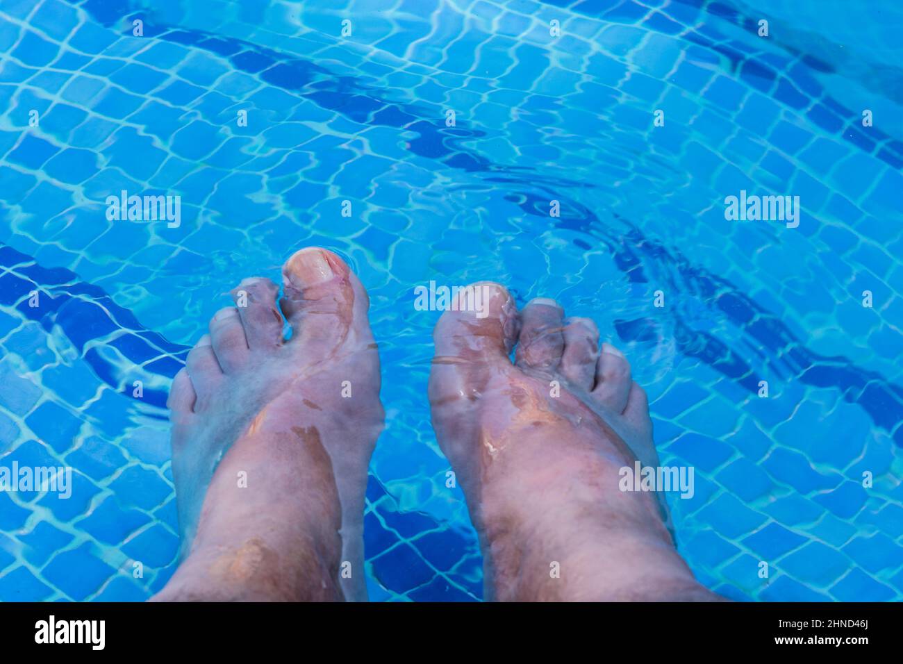 Relaxed day with feet in water Stock Photo - Alamy