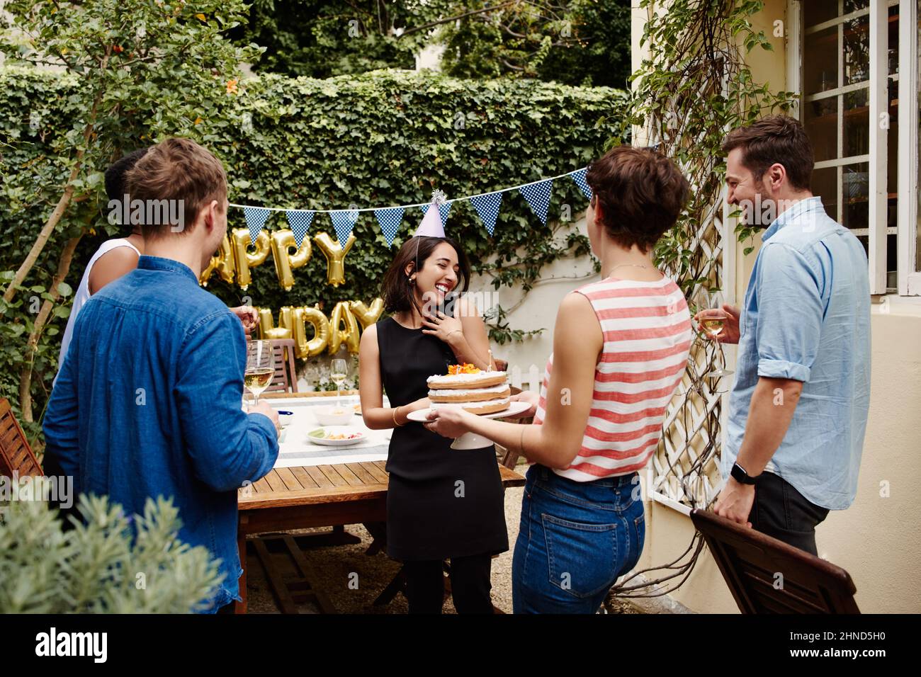 Woman presenting birthday cake hi-res stock photography and images - Alamy