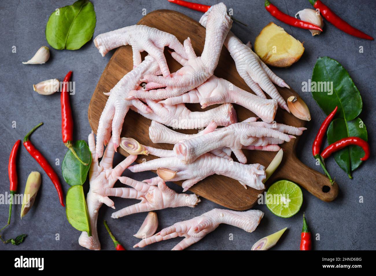 Fresh raw chicken feet for cooked food soup on the dark table kitchen ...