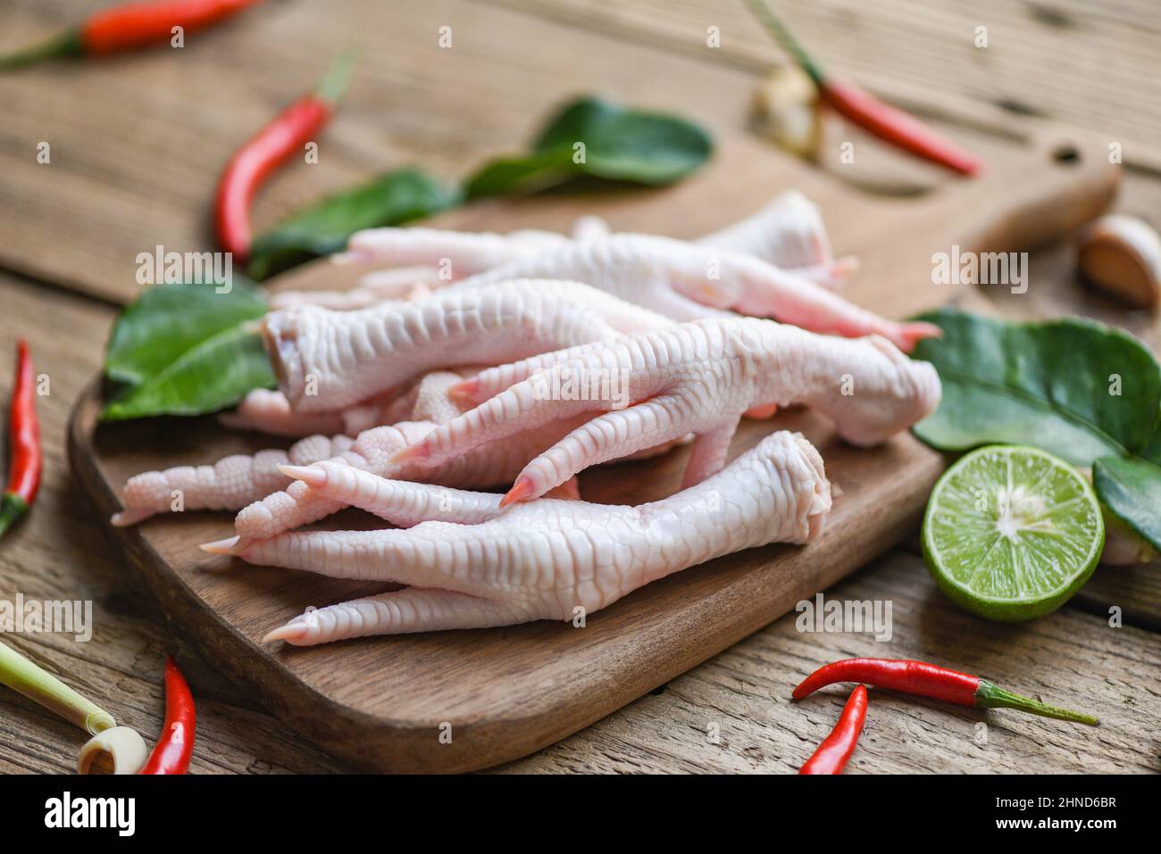 Fresh raw chicken feet for cooked food soup on the dark table kitchen ...