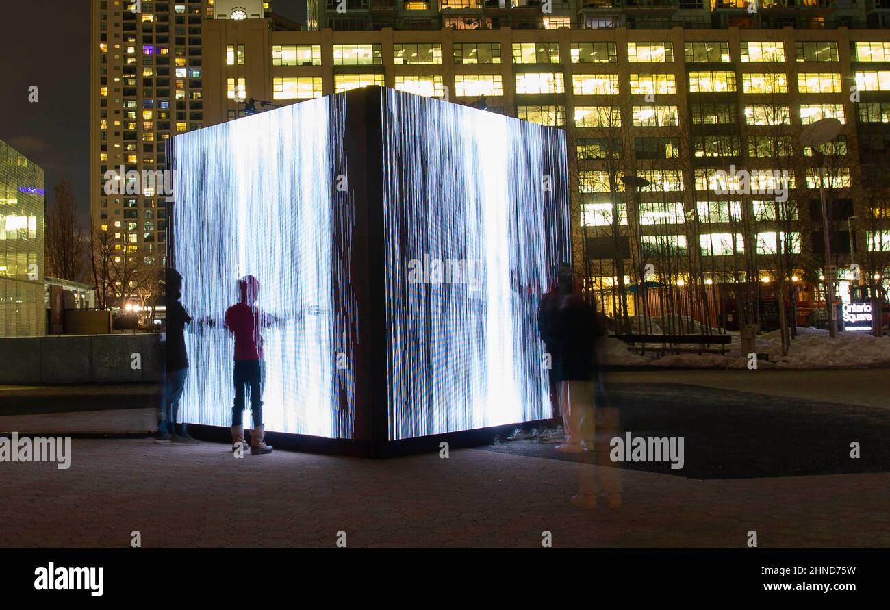 Toronto, Canada. 15th Feb, 2022. People interact with a light art ...