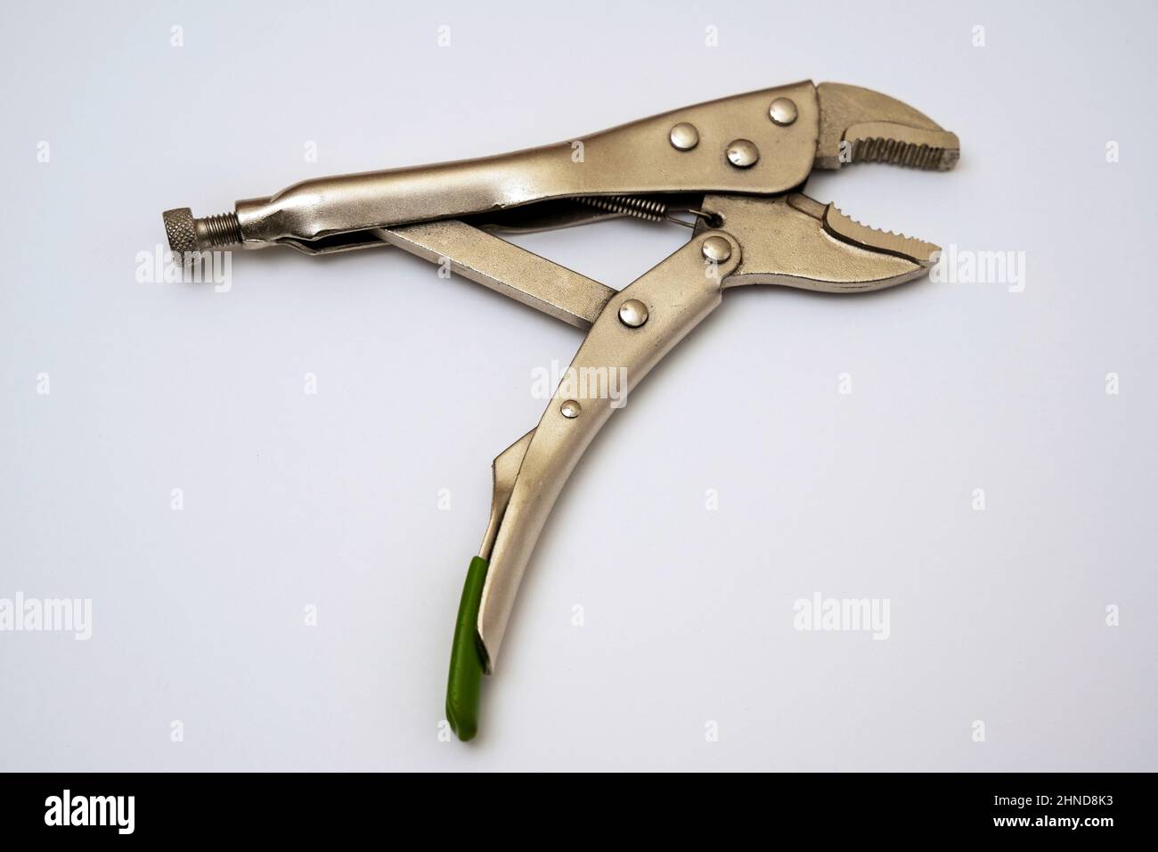 open locking pliers on a white background. Artisan's hand tool close-up ...