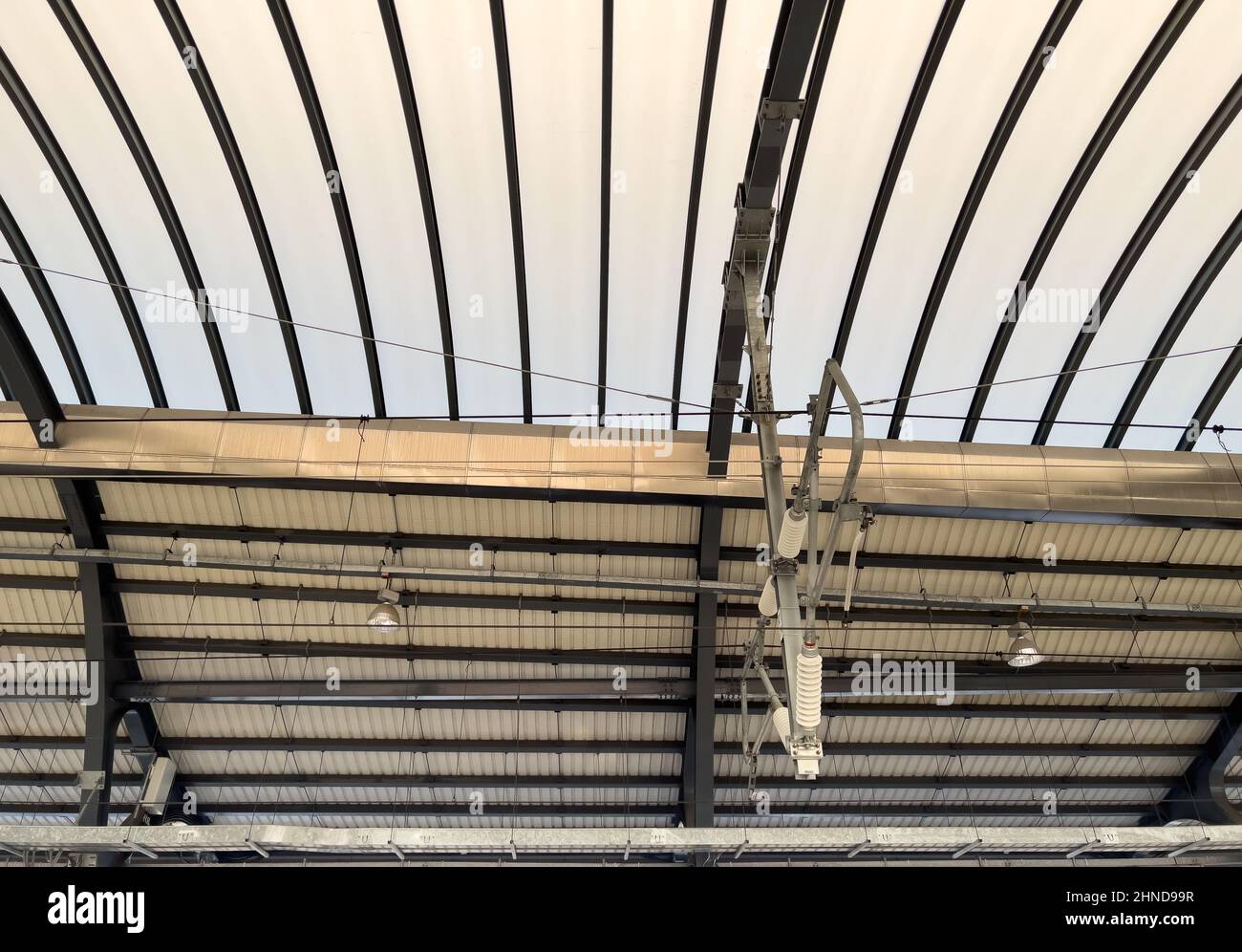 The overhead electric wire is hanging on the ceiling in the platform ...