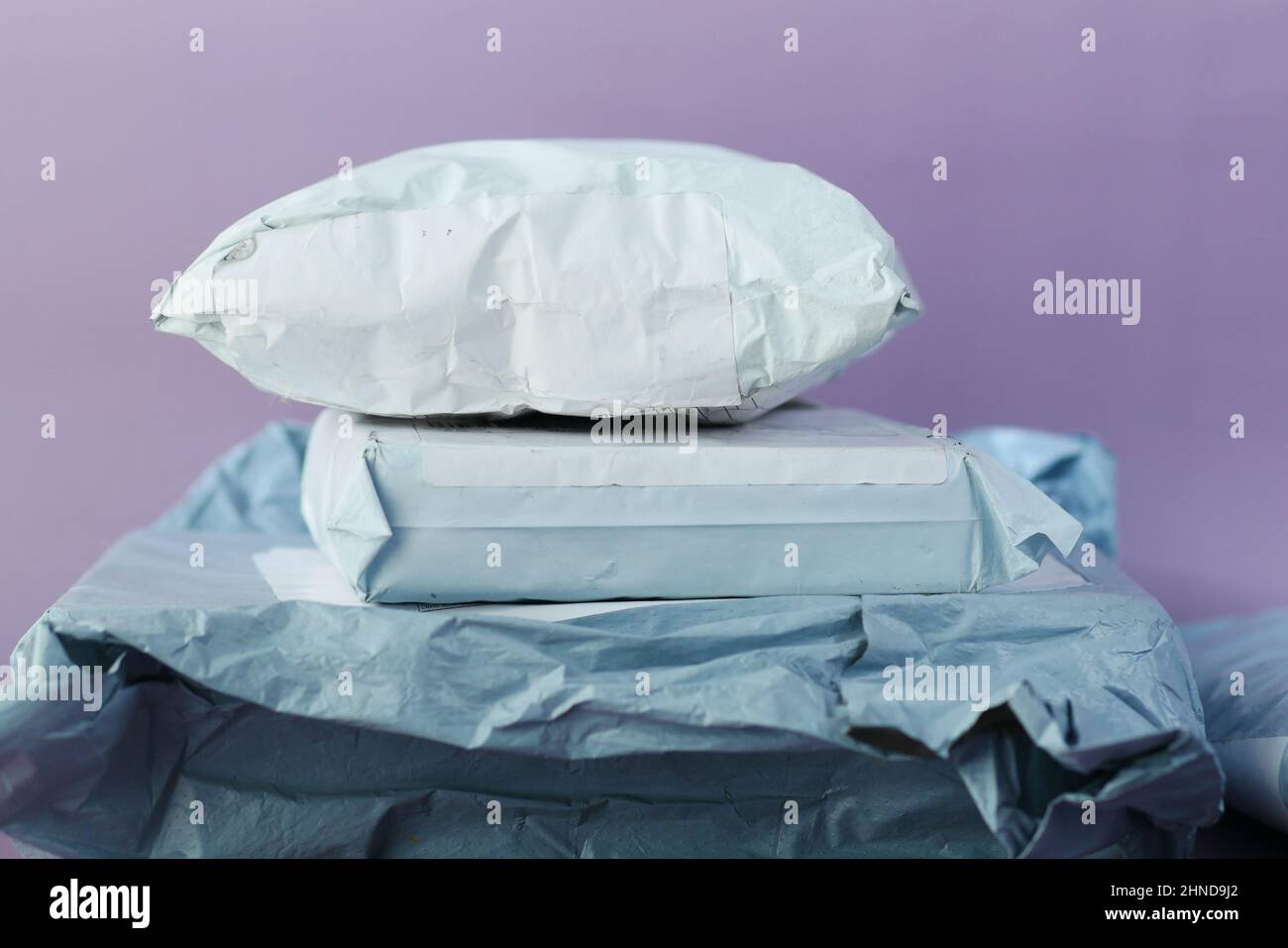 stack of delivery package on color background Stock Photo - Alamy