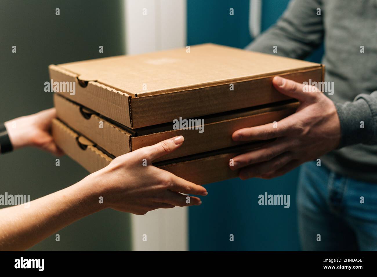 Close-up cropped shot of woman customer receiving carton boxes with ...