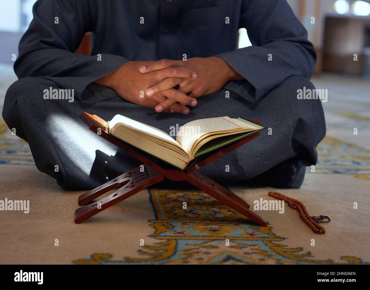 A close up of the Quran on a stand inside a mosque Stock Photo - Alamy