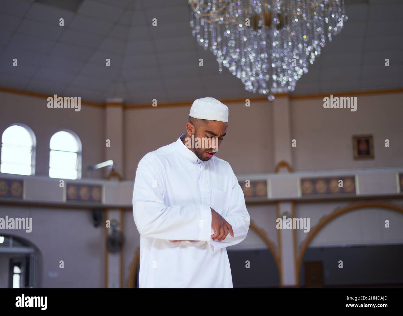 A Muslim man standing during prayers at a mosque Stock Photo - Alamy