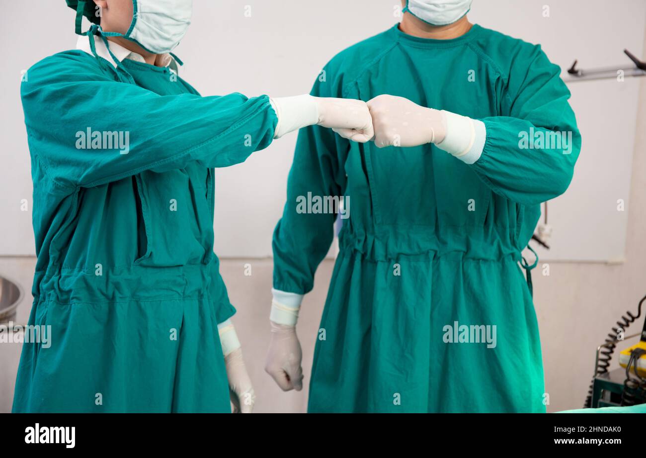 Teamwork of doctor and assistant fist bump or knuckle bump with success ...