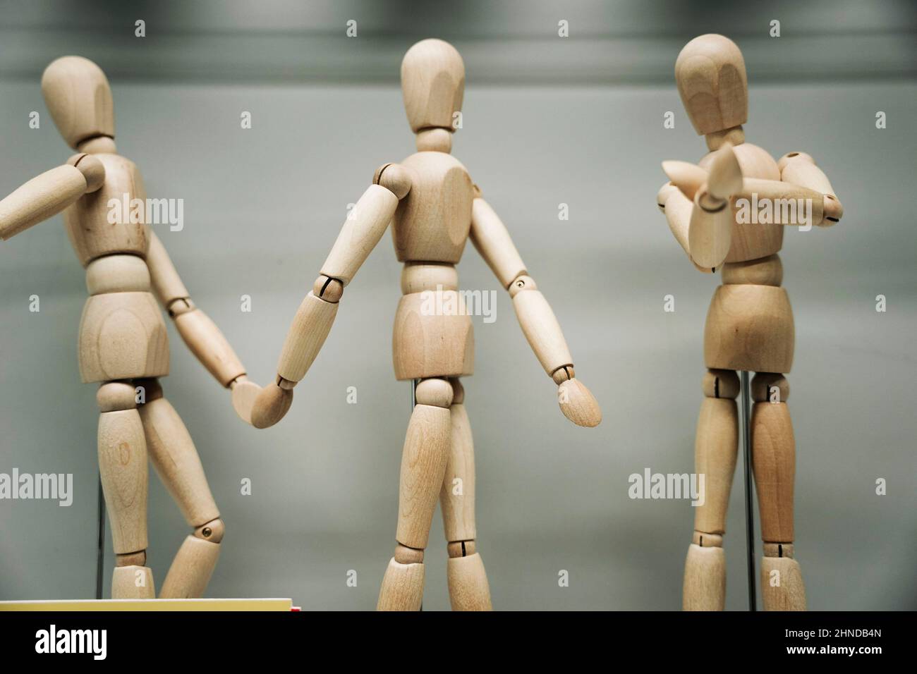 wooden figures of people holding hands, three figures of people ...