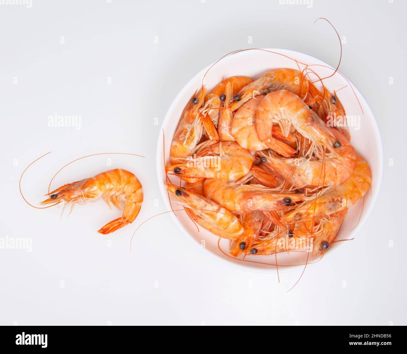 Red sea shrimp in dish on the white background Stock Photo - Alamy