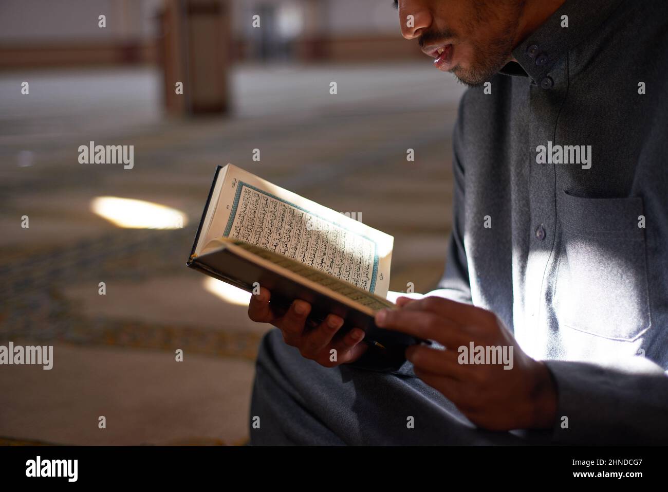Portrait of a young Muslim male reading the Quran inside a mosque Stock ...