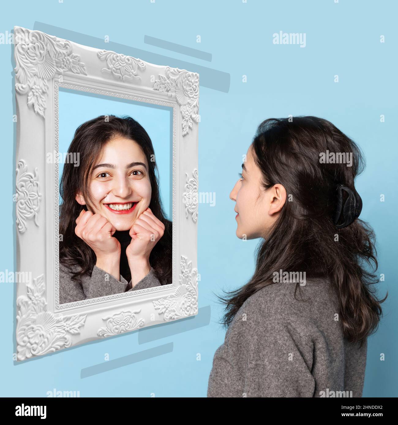 Smiling Young Girl Looking At Mirror Isolated On Light Background