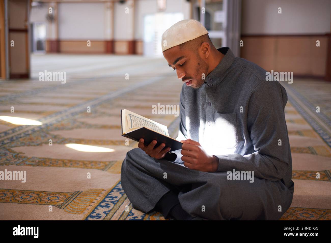 Portrait of a young Muslim male reading the Quran inside a mosque Stock ...