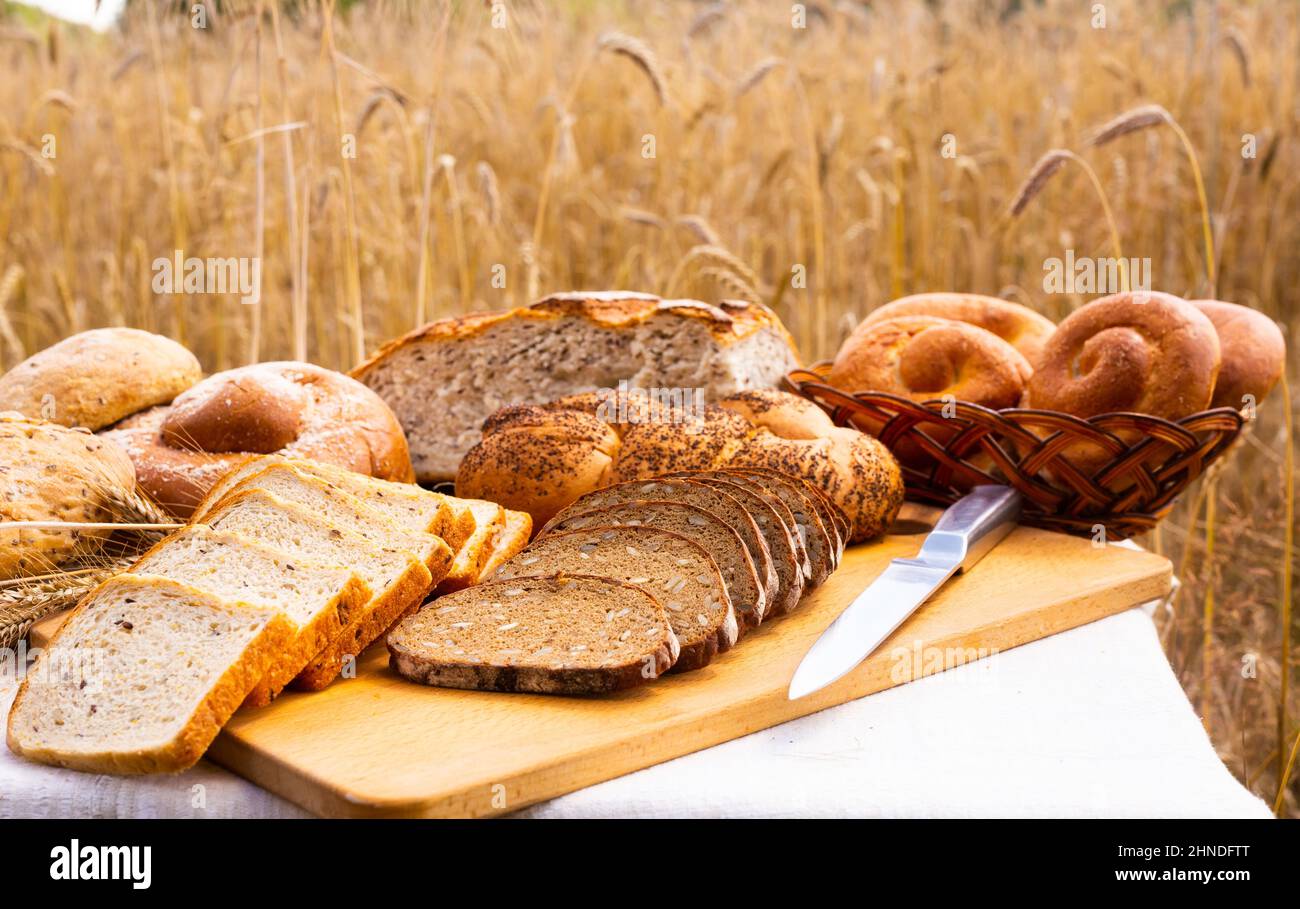 lot of different flavored bread, wheat, rye, on the table in the field ...