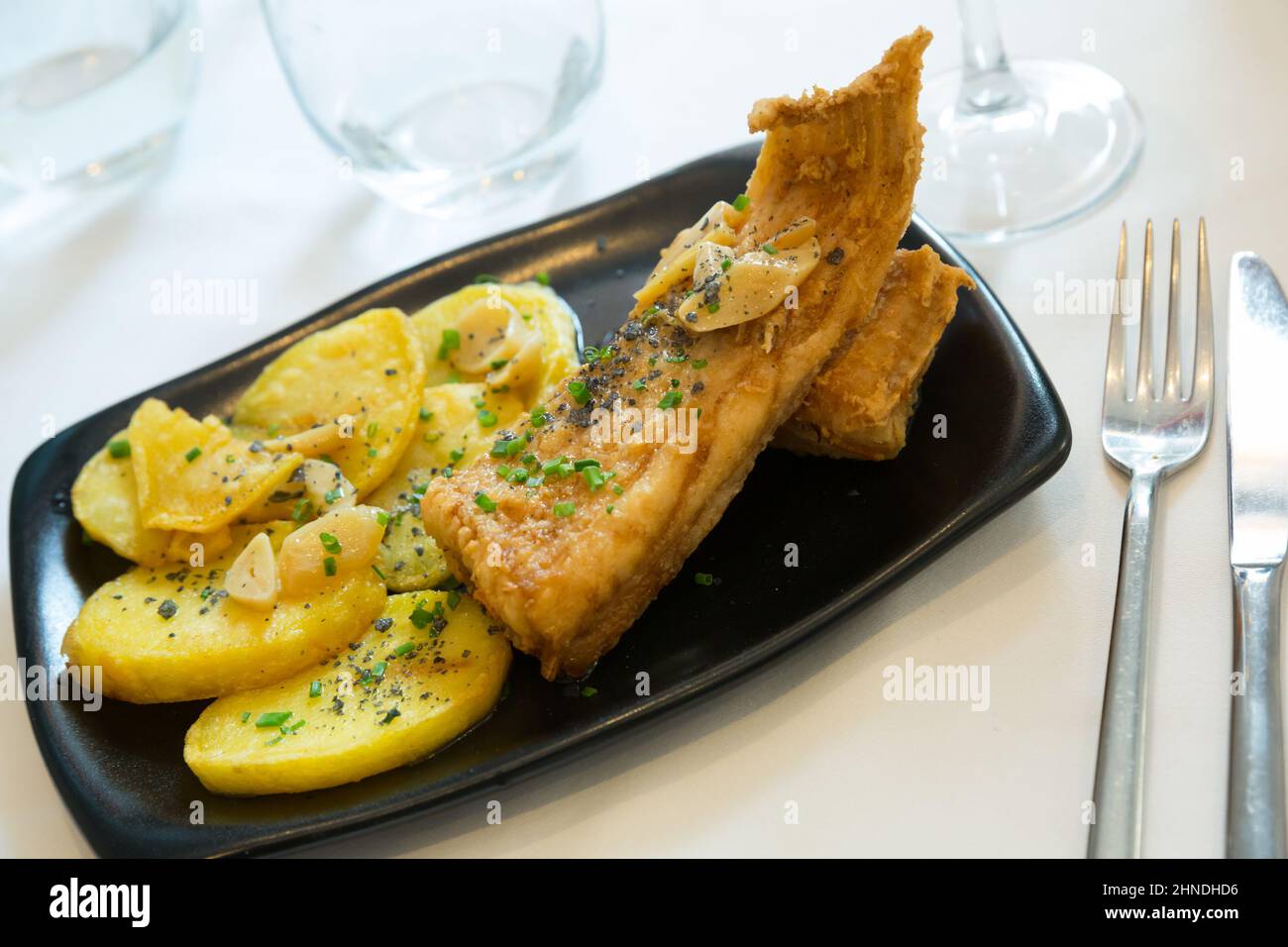 Roasted ray wings with potatoes Stock Photo - Alamy