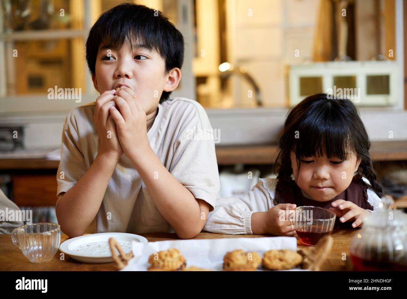 Japanese Brother And Sister Taking A Break Stock Photo - Alamy