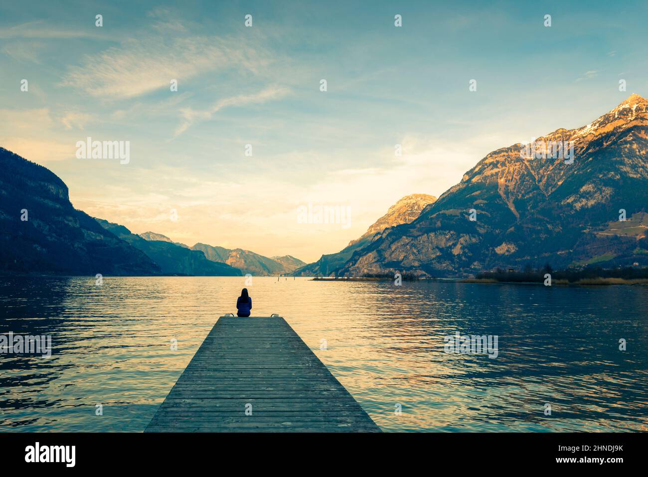 Small female figure in the epic mountain landscape Stock Photo - Alamy