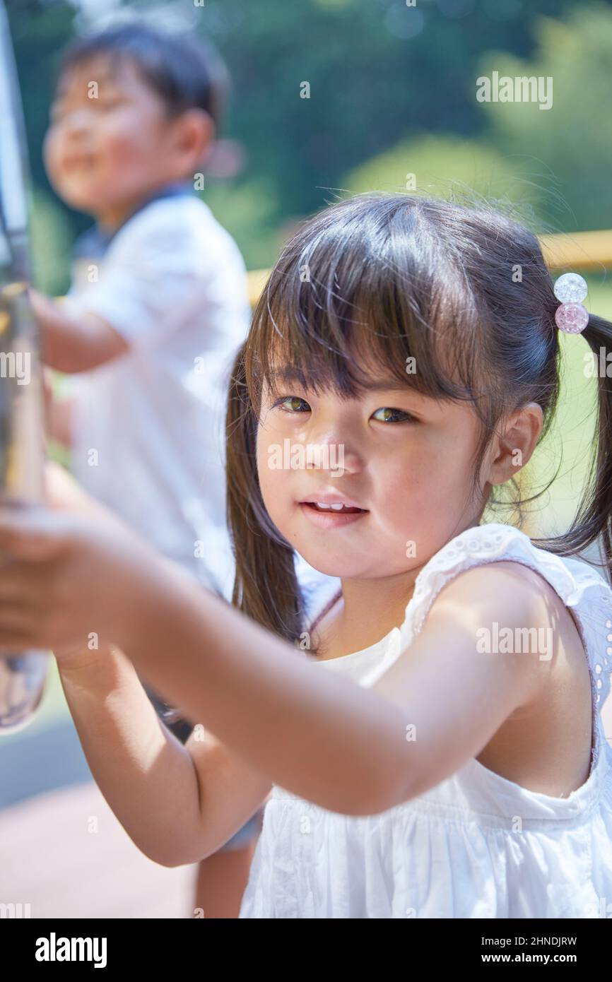 Asian girl playing playground hi-res stock photography and images - Alamy