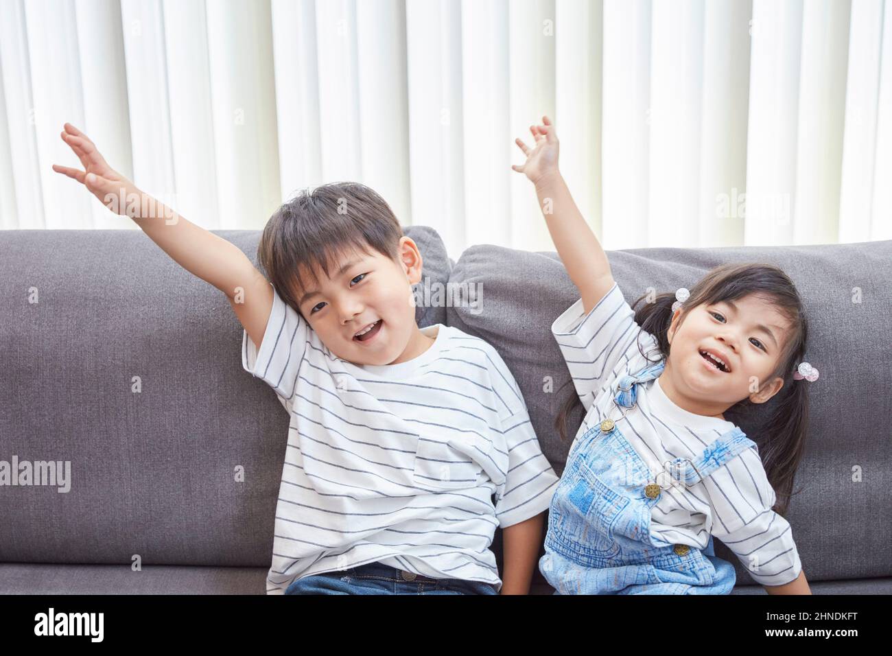 Japanese Brother And Sister Raising Their Hands Stock Photo - Alamy