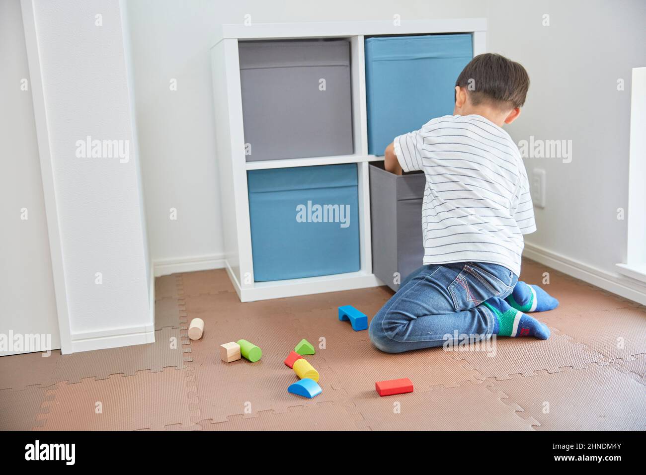 Japanese Boy Cleaning Up His Toys Stock Photo - Alamy