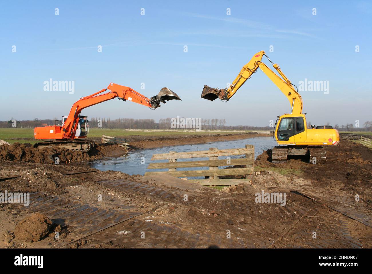 Two cranes with backhoe in action in Dutch polder landscape Stock Photo ...