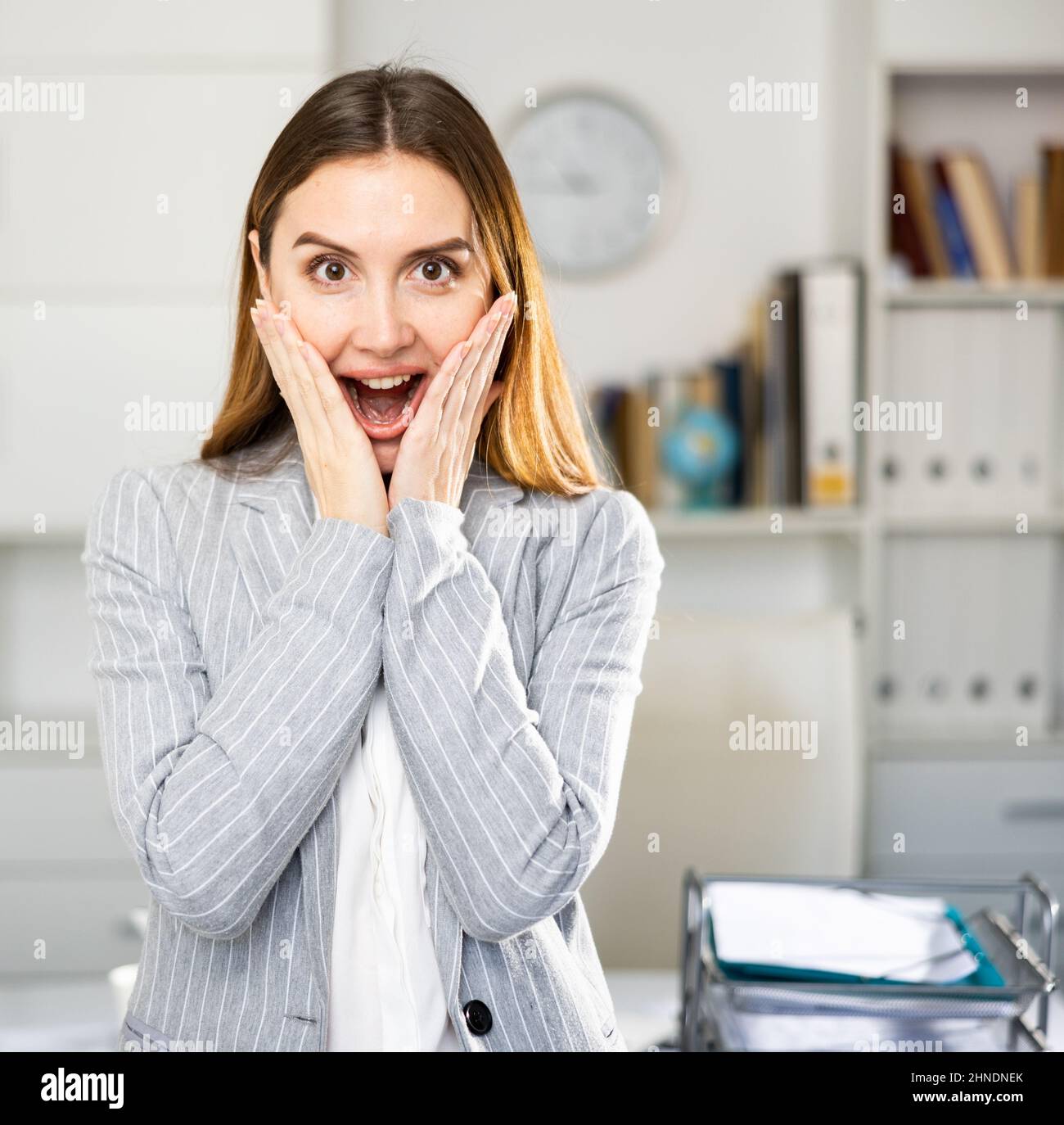 Woman manager expresses various positive emotions in modern office ...