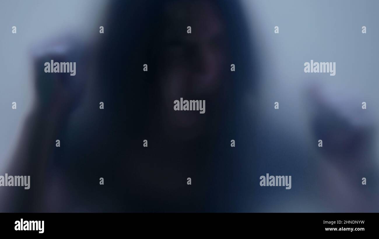 Defocused shot of person trapped in emotional problems behind glass ...