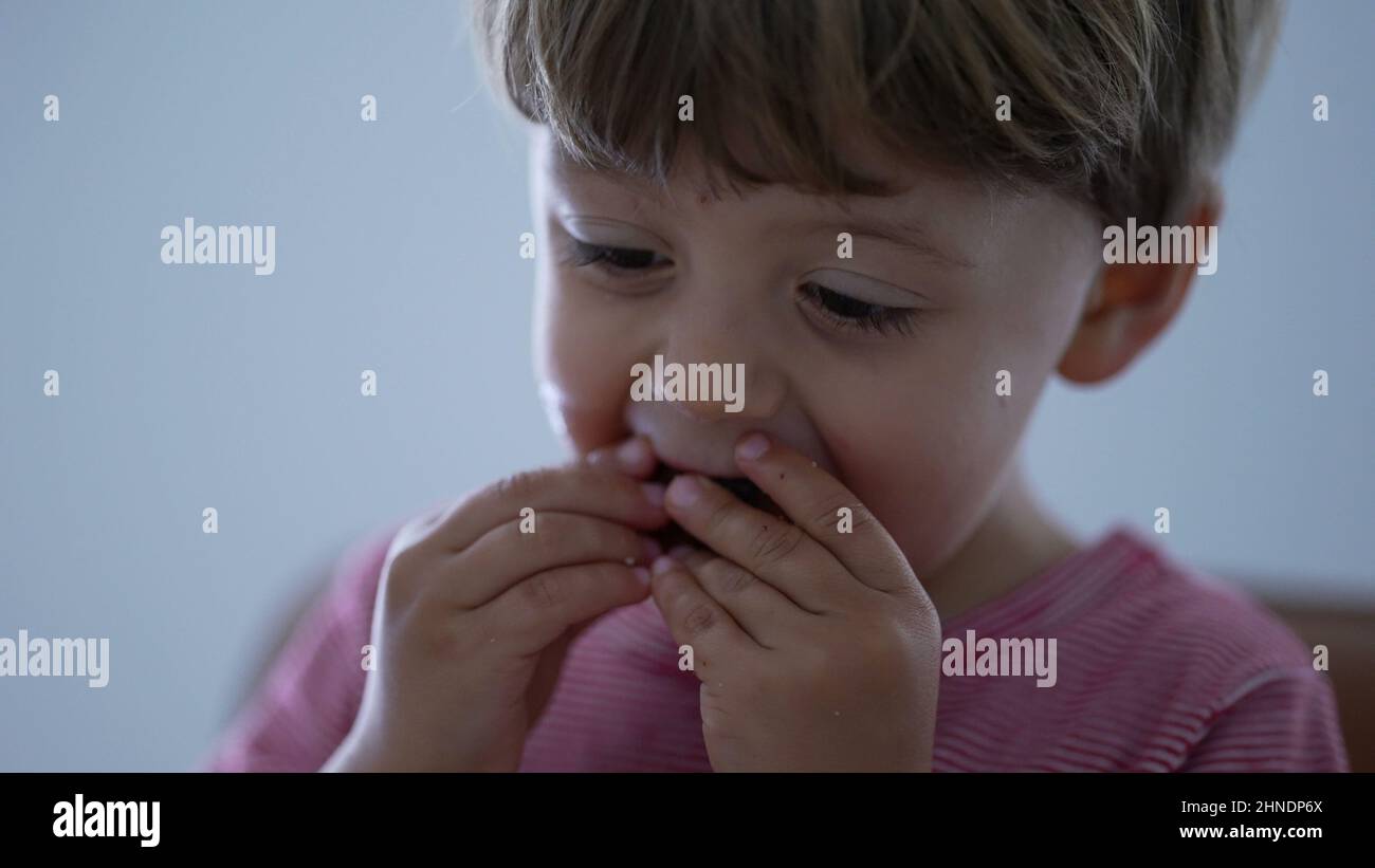 Little boy eating piece of bread child eats carb food Stock Photo - Alamy
