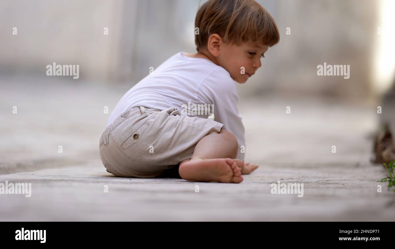 Little boy falling on the ground and getting up child stands up Stock ...