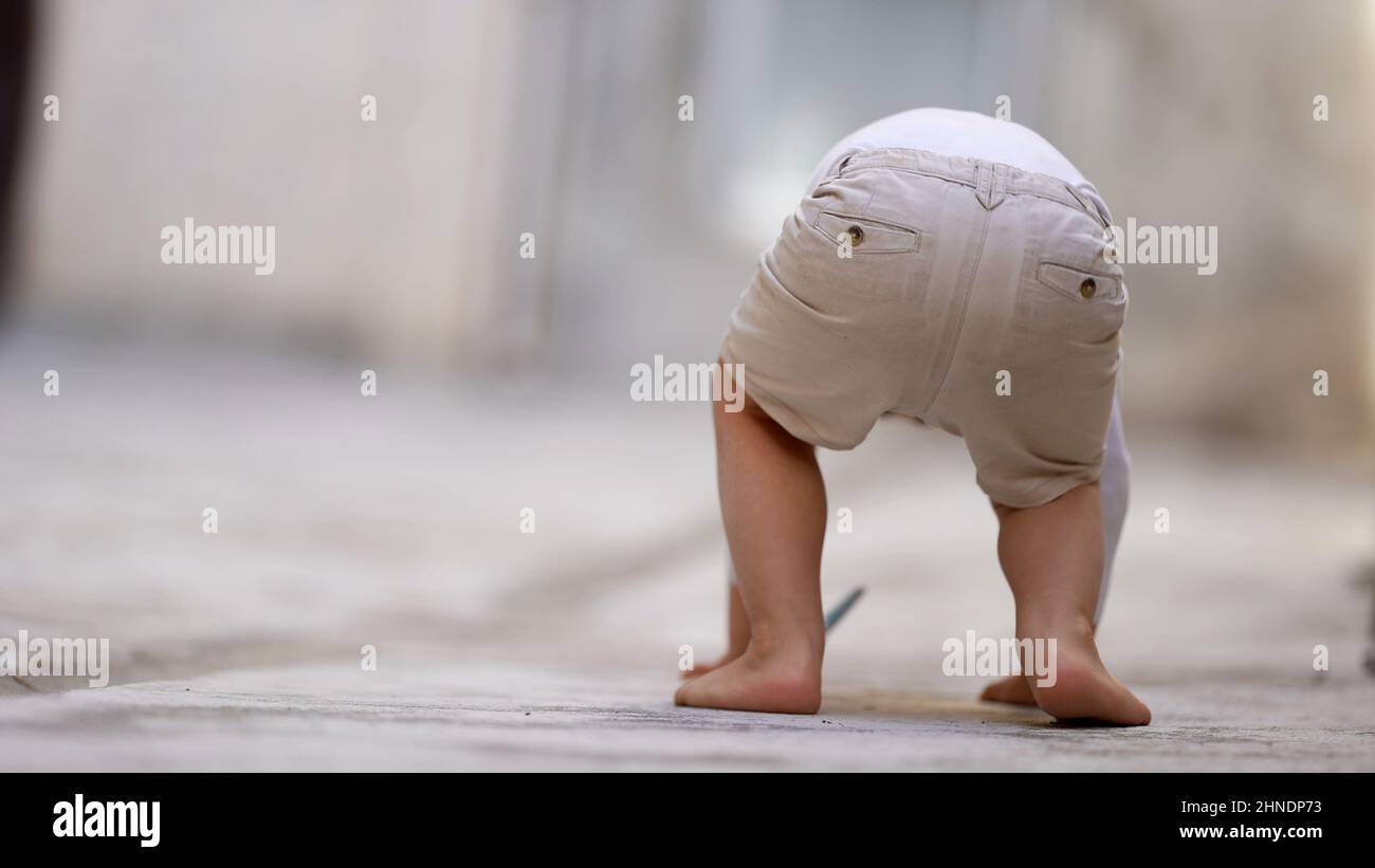 Little boy falling on the ground and getting up child stands up Stock ...