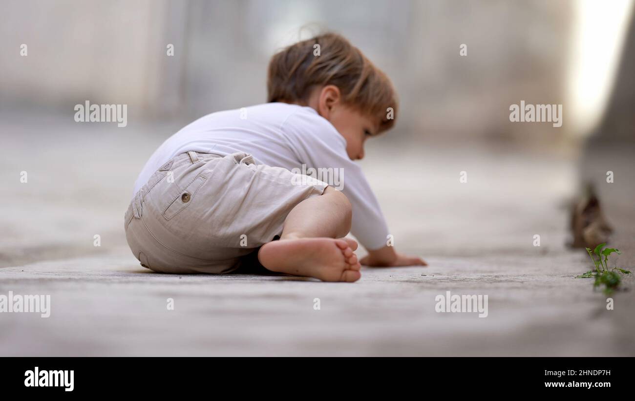 Little boy falling on the ground and getting up child stands up Stock ...