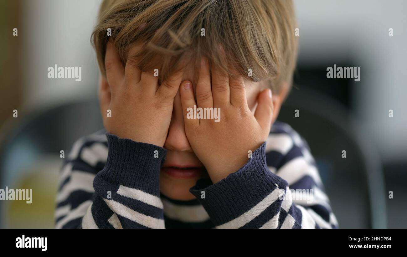 Little boy reaction OH NO covering face with hands Stock Photo - Alamy