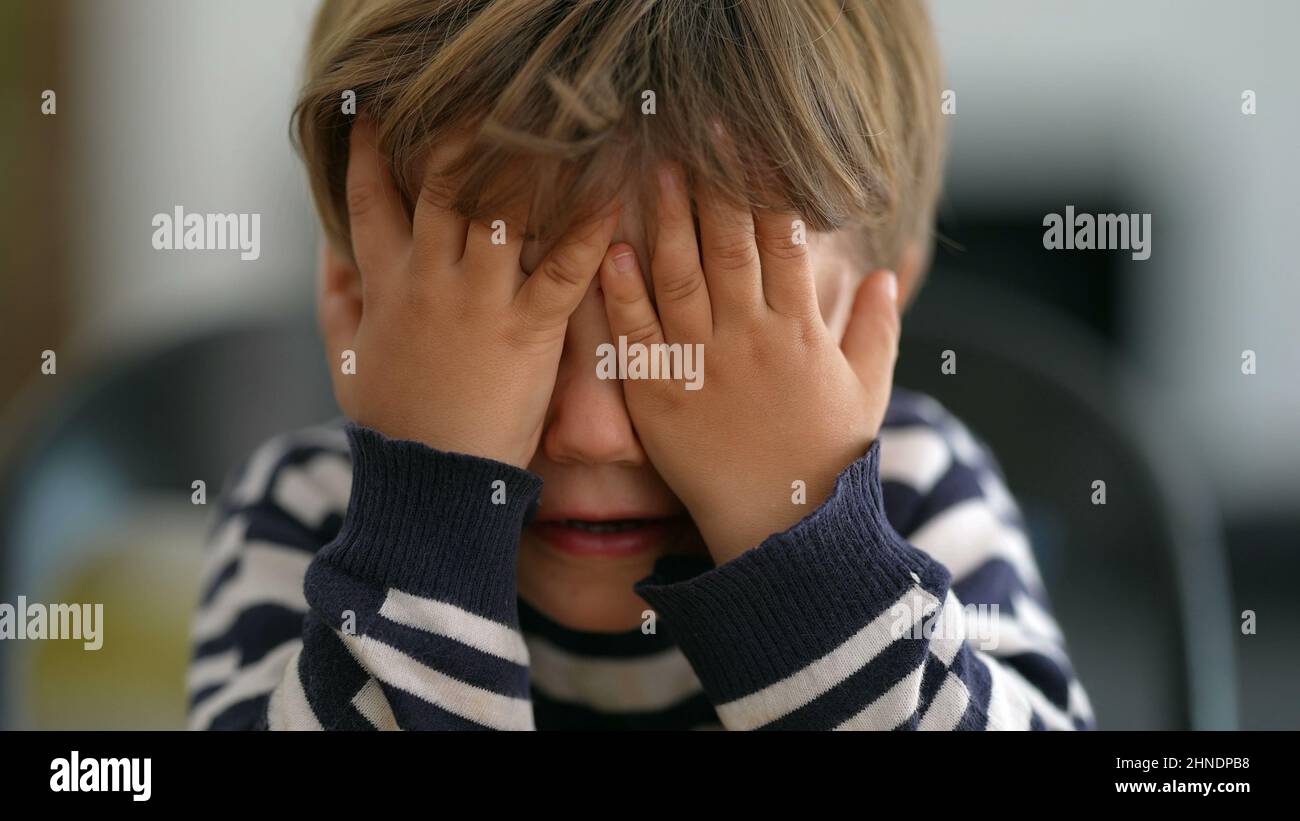 Little boy reaction OH NO covering face with hands Stock Photo - Alamy