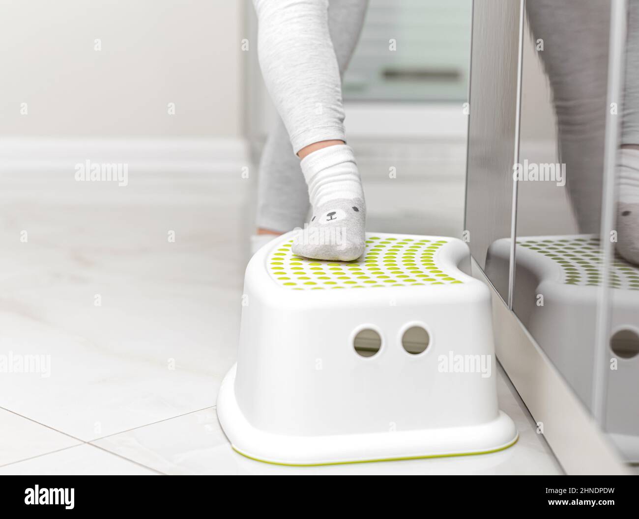 Small feet stand on a stand for children Stock Photo - Alamy