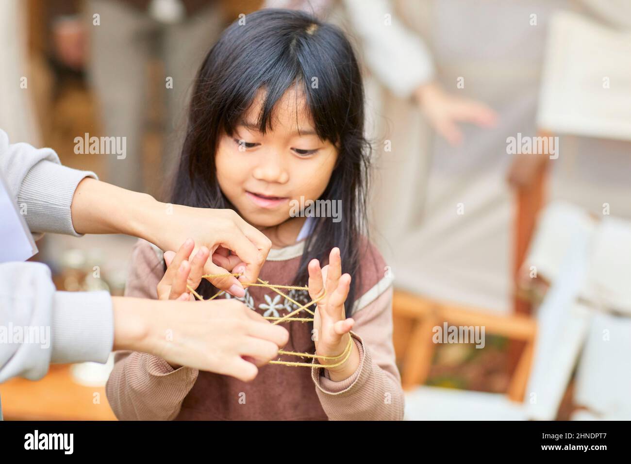 Japanese Girl Enjoying Playing Ayatori Stock Photo - Alamy