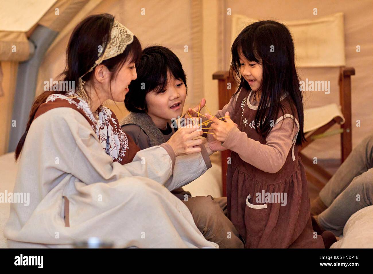 Japanese Family Enjoying Playing Ayatori Stock Photo - Alamy
