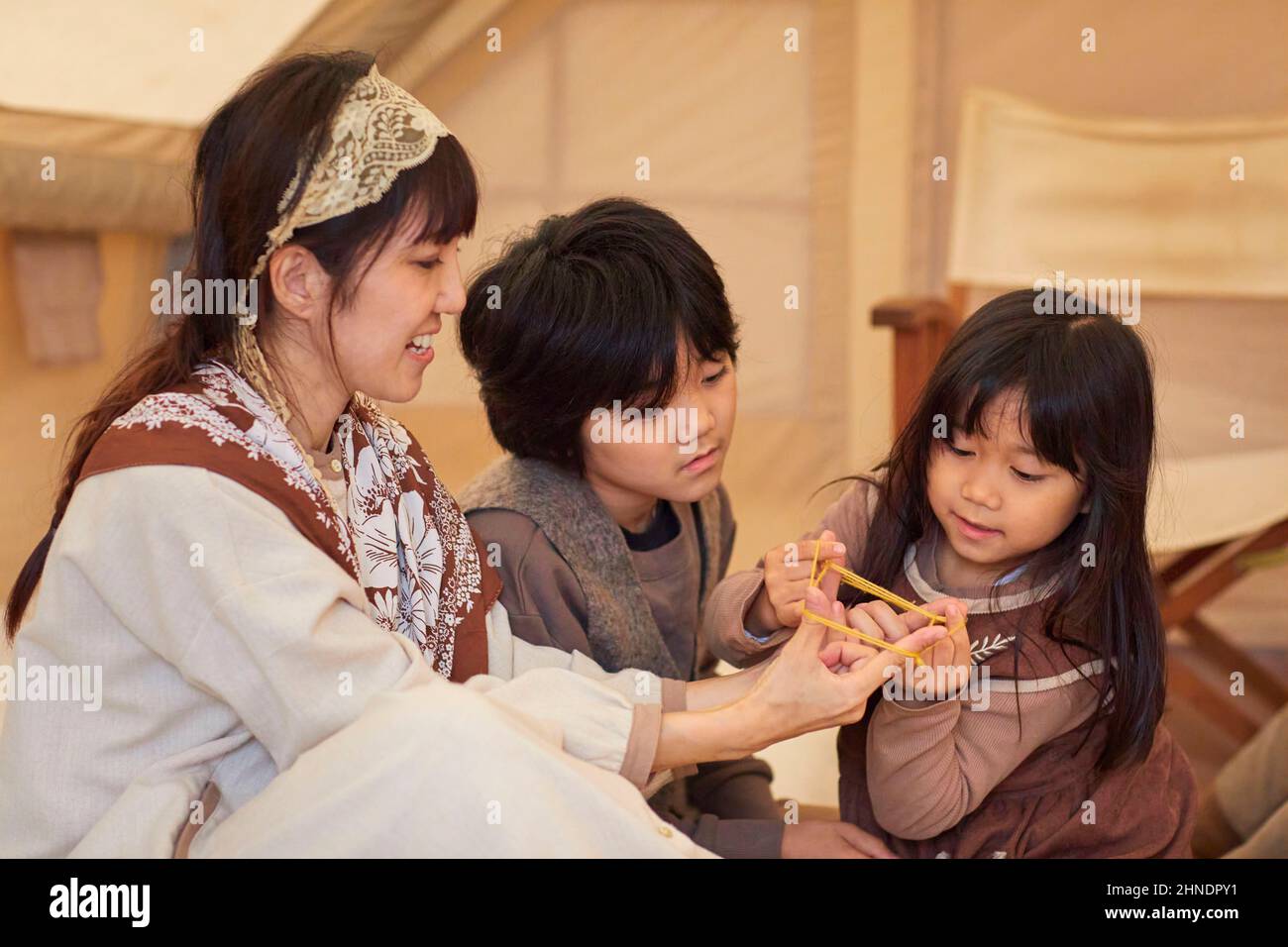 Japanese Family Enjoying Playing Ayatori Stock Photo - Alamy