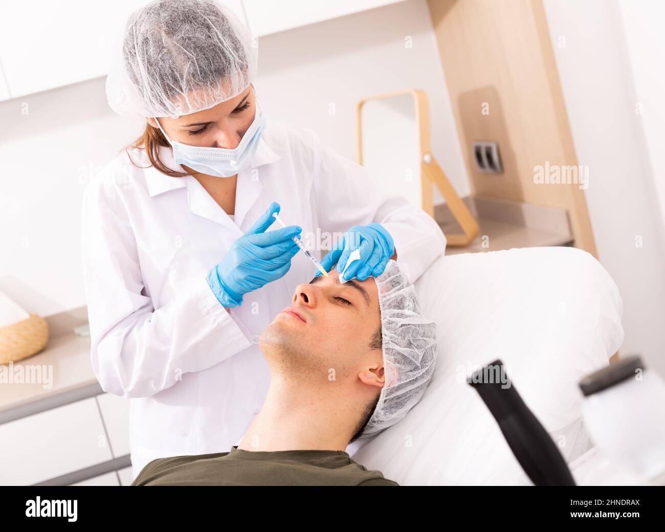 Man getting face injections at aesthetic clinic Stock Photo - Alamy
