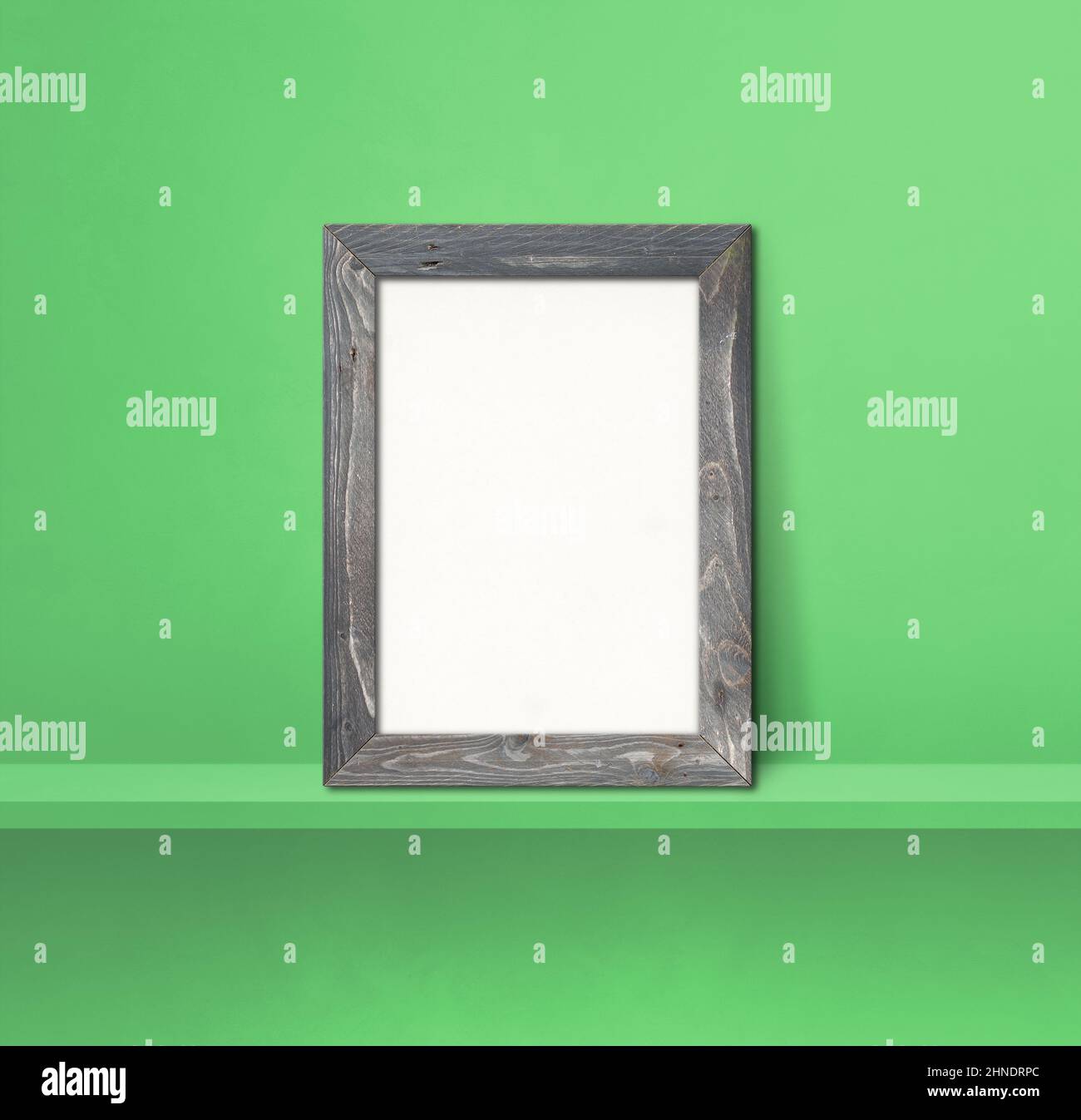 Wooden picture frame leaning on a green shelf. 3d illustration. Blank ...