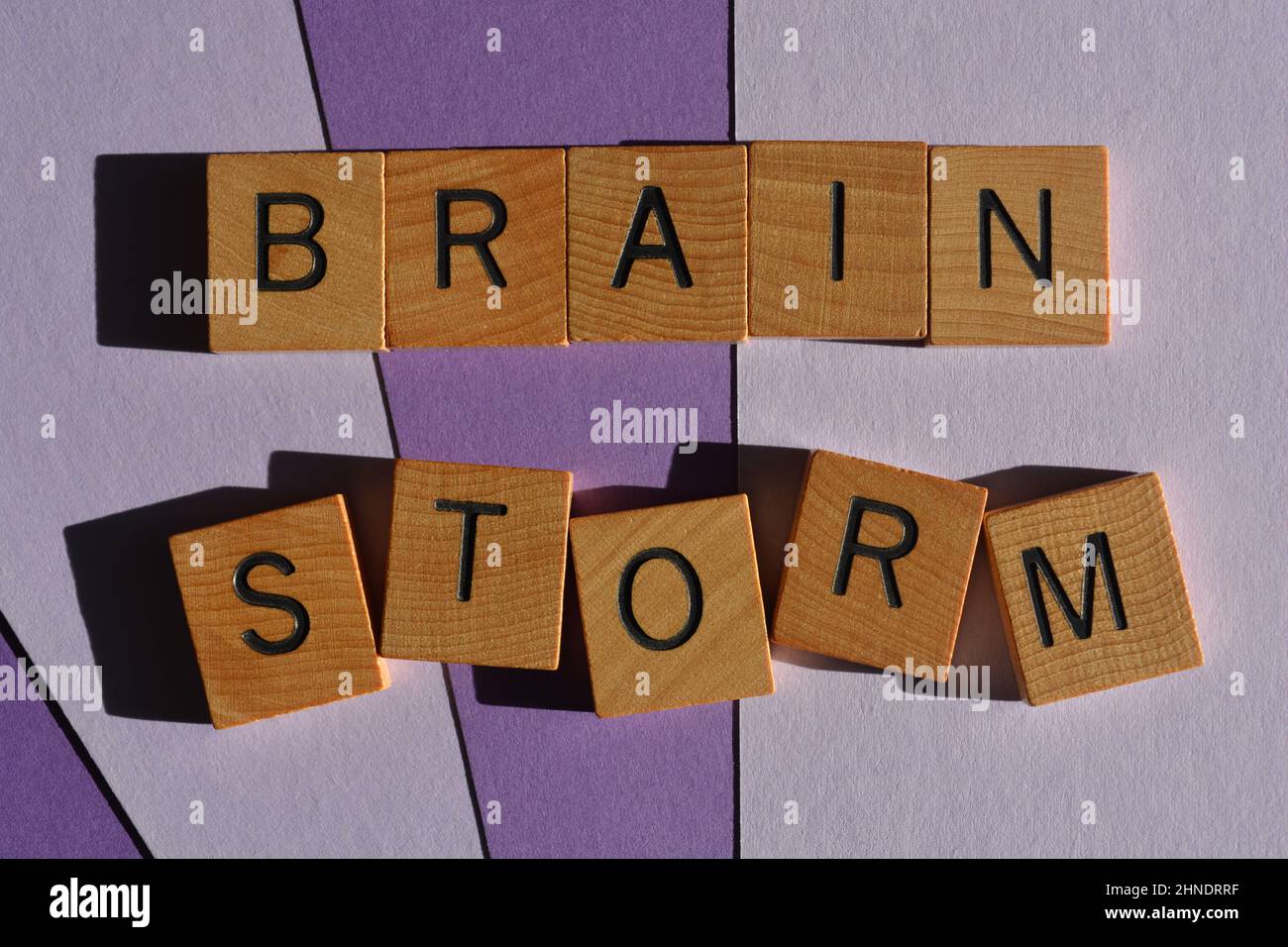Brain Storm, words in wooden alphabet letters isolated on purple ...