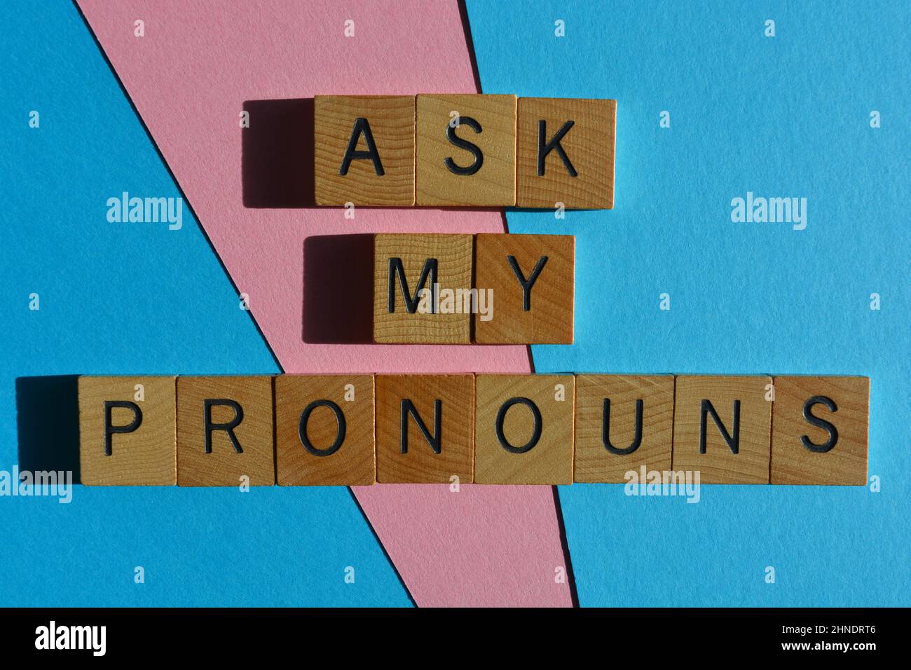 Ask My Pronouns, words in wooden alphabet letters isolated on pink and ...