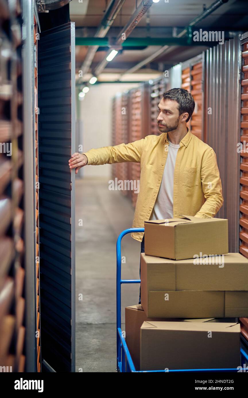 Focused male order picker picking ordered goods Stock Photo - Alamy