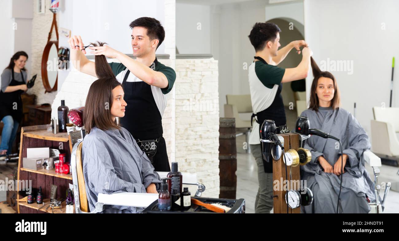 Man professional hairdresser cut female's hair in salon Stock Photo - Alamy