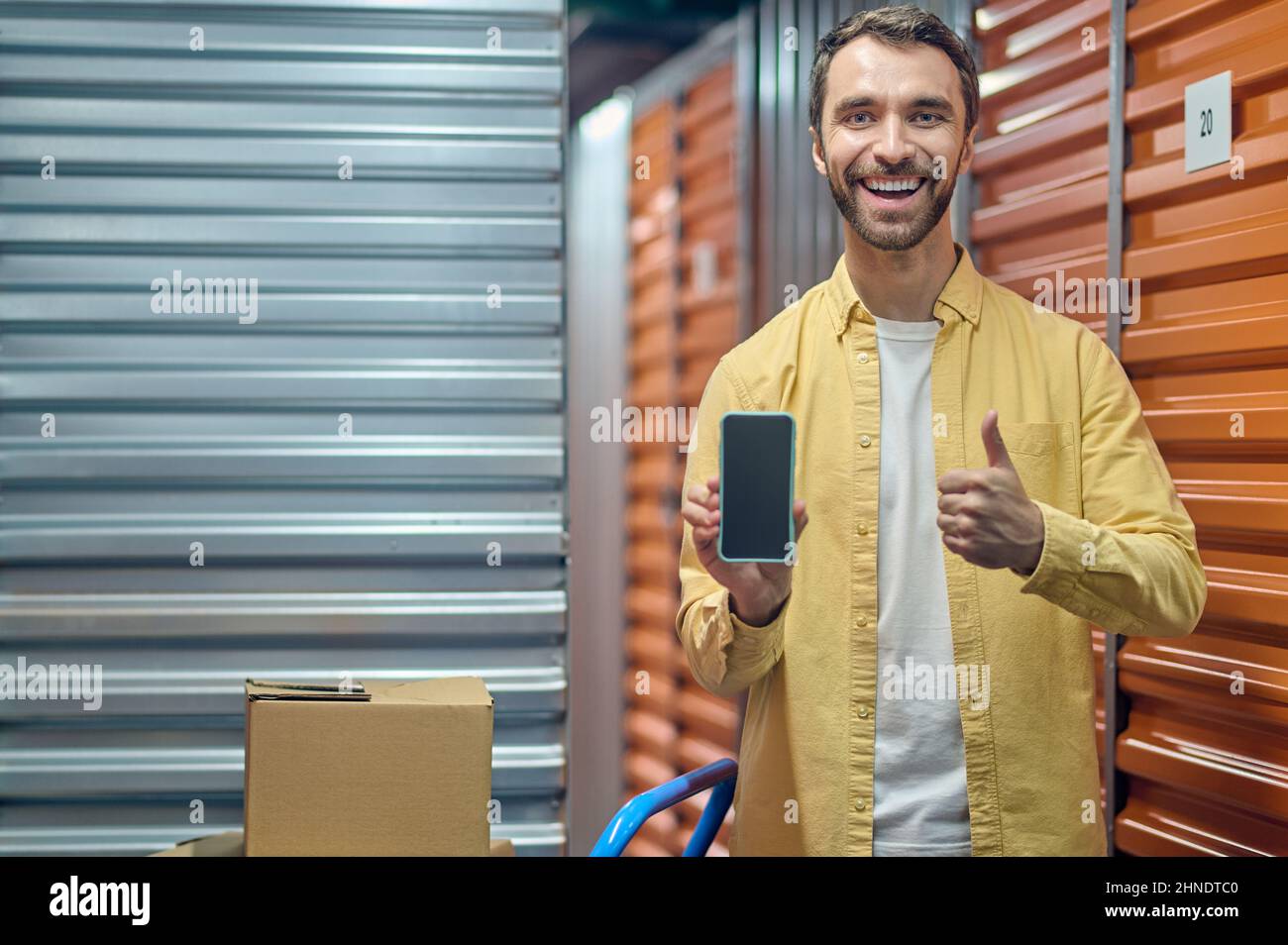 Happy male employee cellphone hi-res stock photography and images - Alamy