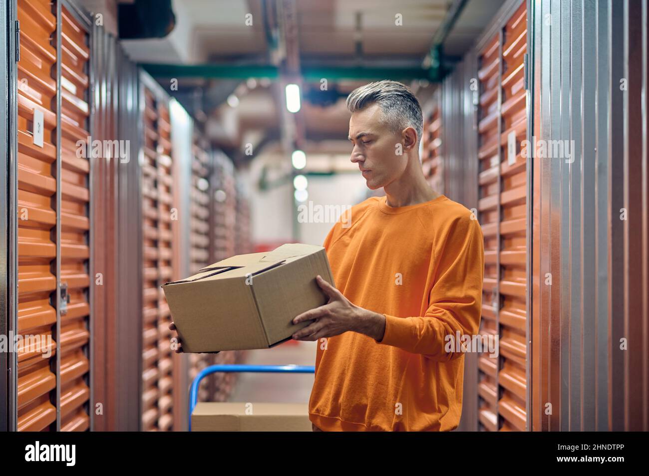 Experienced storehouse worker performing the packaging quality control ...