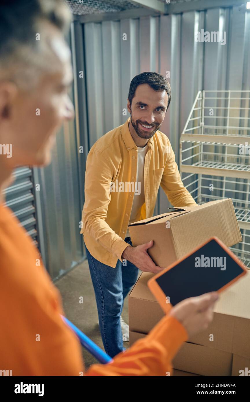 Two storehouse employees preparing items for delivery Stock Photo - Alamy